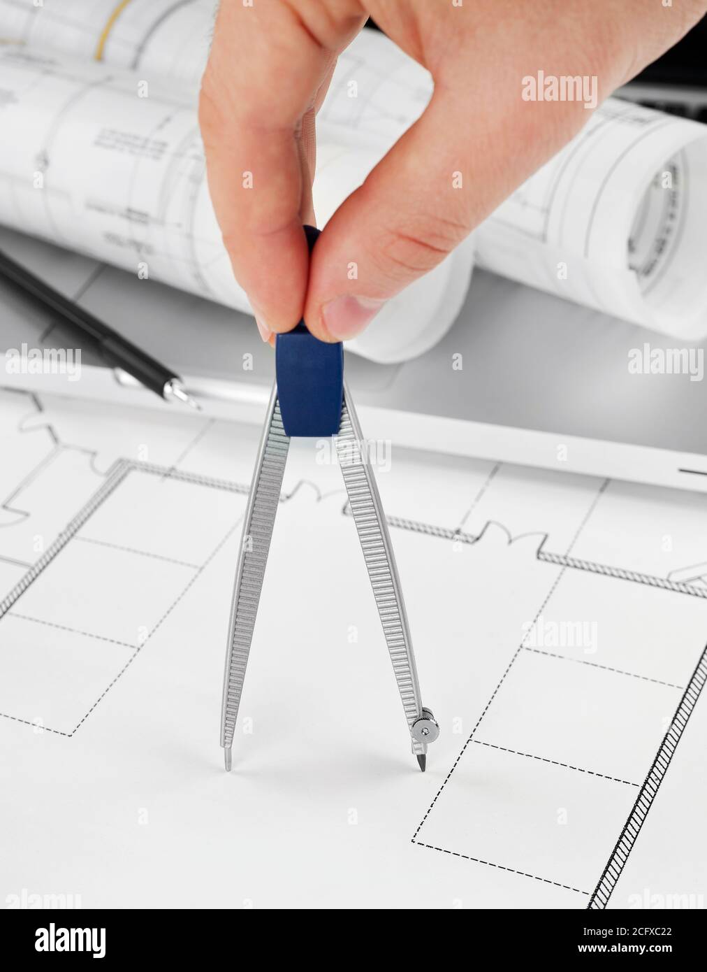 Architect with drawing compass on blueprint Stock Photo - Alamy