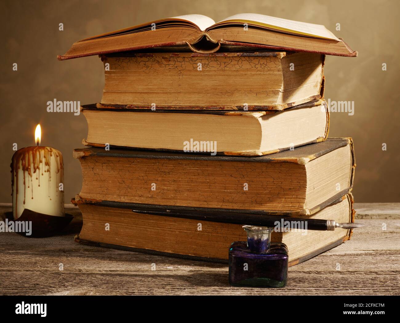 Ink pot, quill, candle and antique books Stock Photo - Alamy