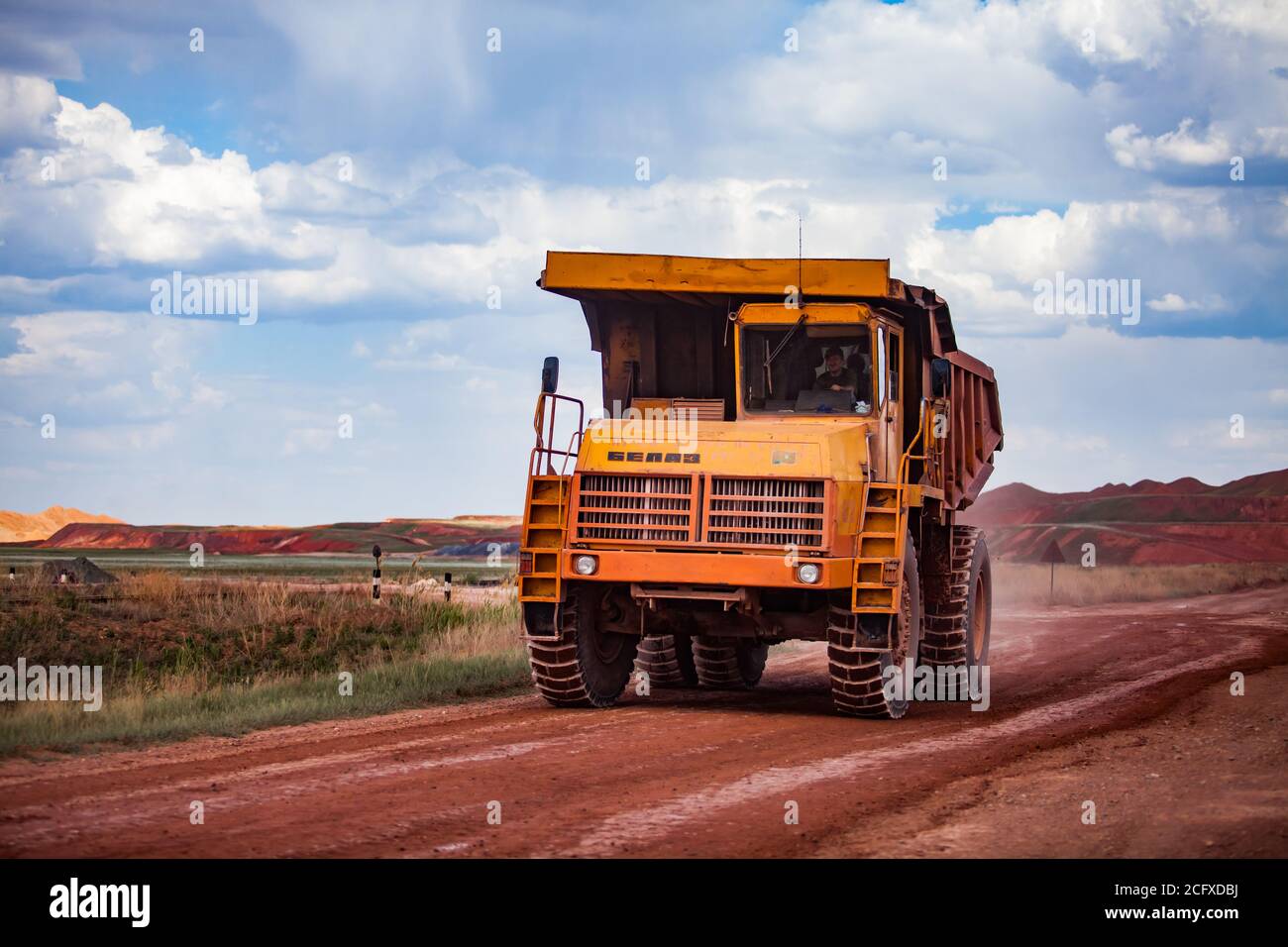 Aluminium ore mining and transporting. Bauxite clay. Large quarry dump ...