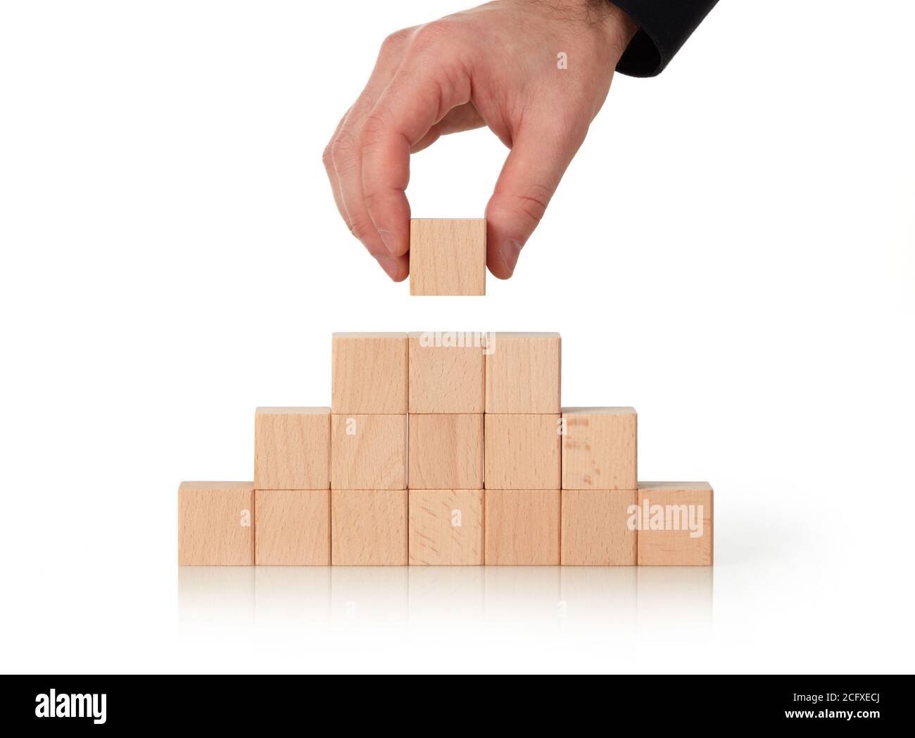 Wooden blocks pyramid, white background Stock Photo - Alamy