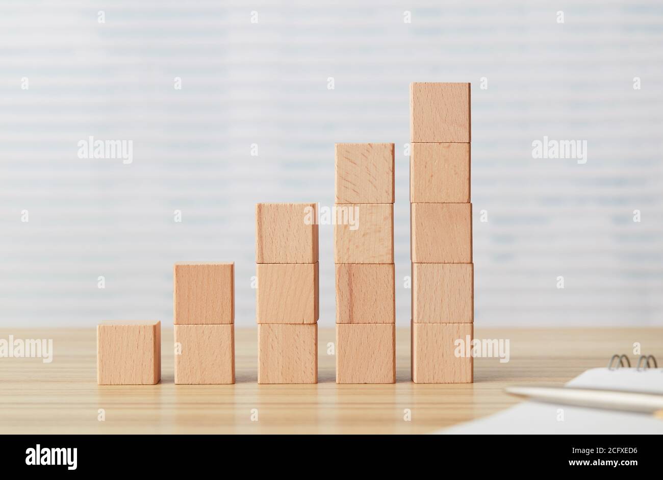 Wooden cubes on office desk Stock Photo - Alamy