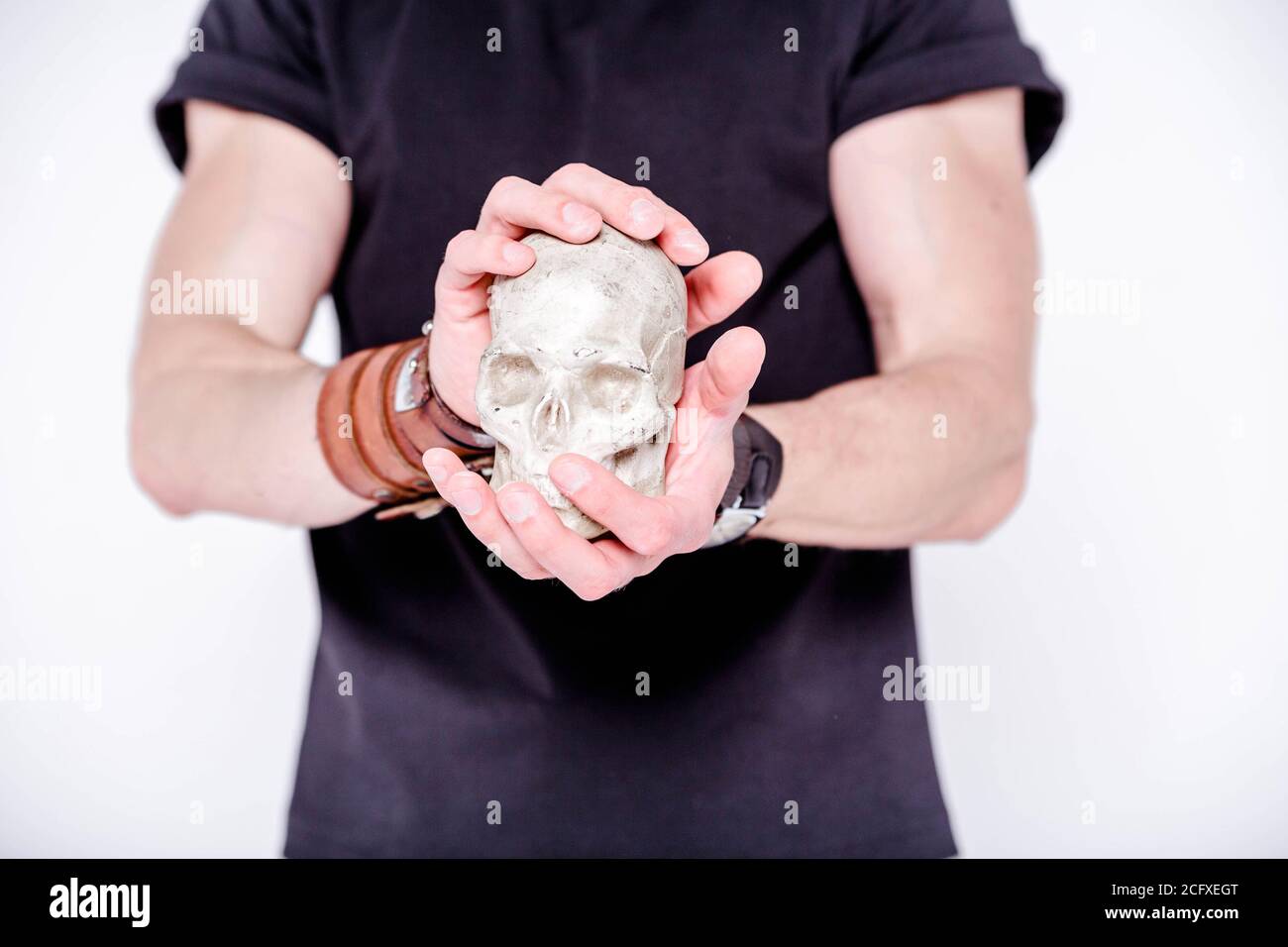Hand holding human skull hi-res stock photography and images - Alamy