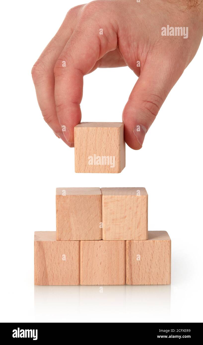 Wooden blocks pyramid, white background Stock Photo - Alamy