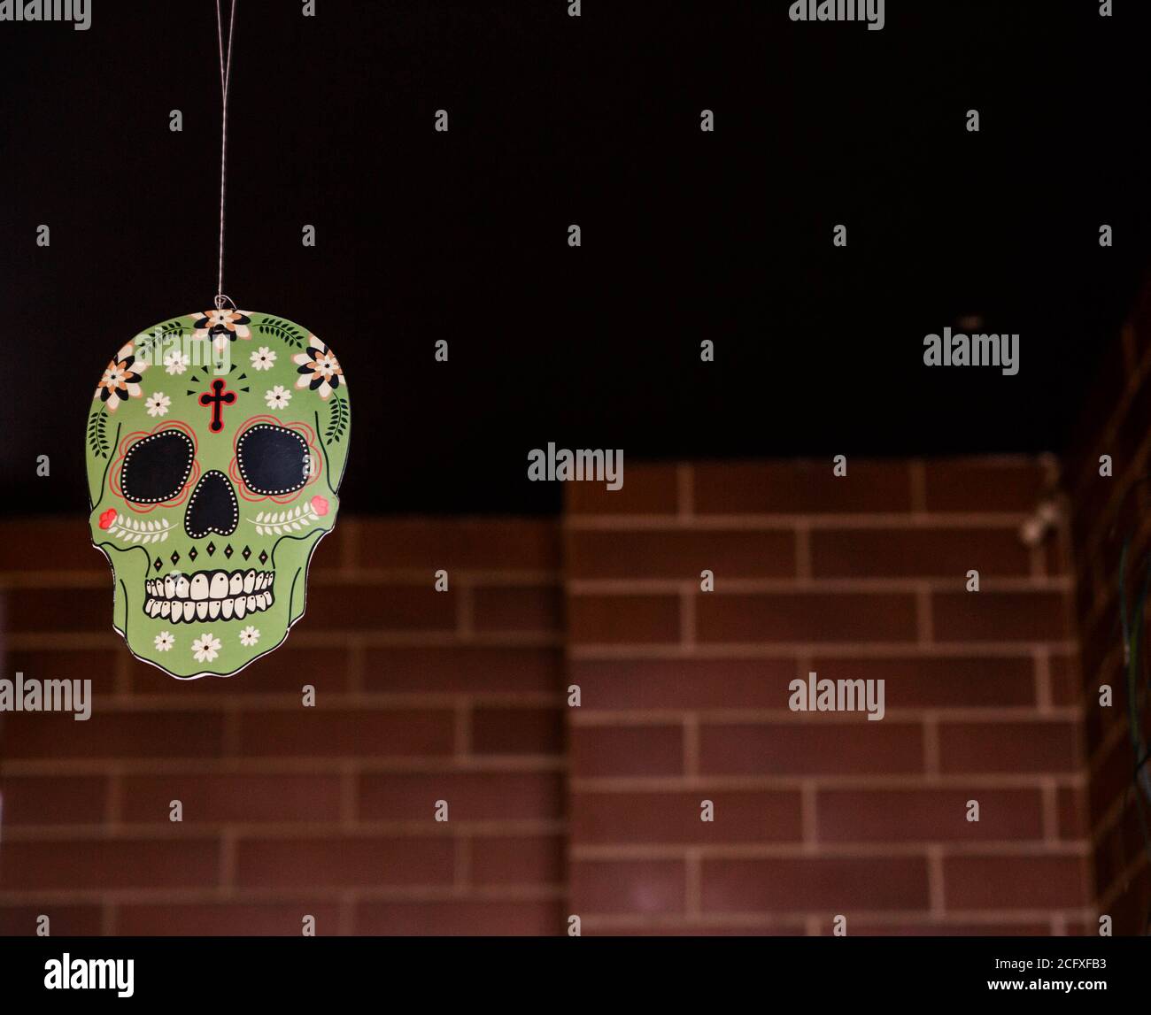Halloween party paper mask hanging on brick wall background Stock Photo ...