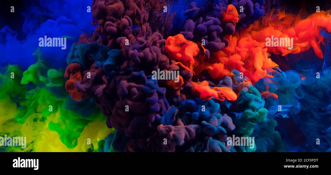 Mix of coloured inks in water on black background. Abstract colored ...