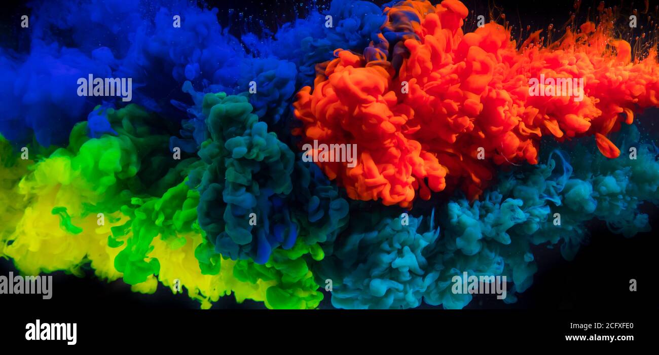 Mix of coloured inks in water on black background. Abstract colored ...