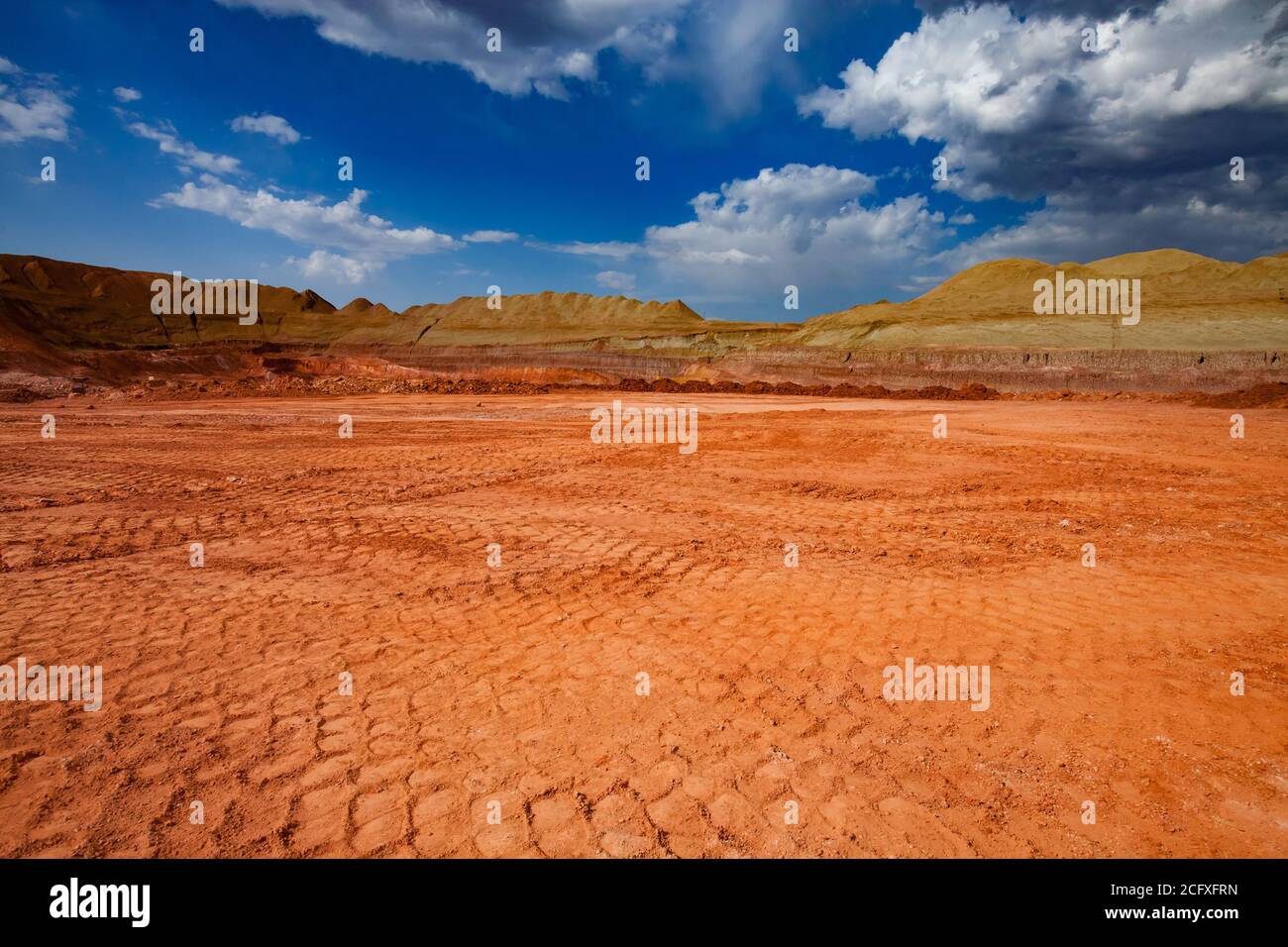 Aluminium ore quarry. Bauxite clay open-cut mining. Truck trails on the ...