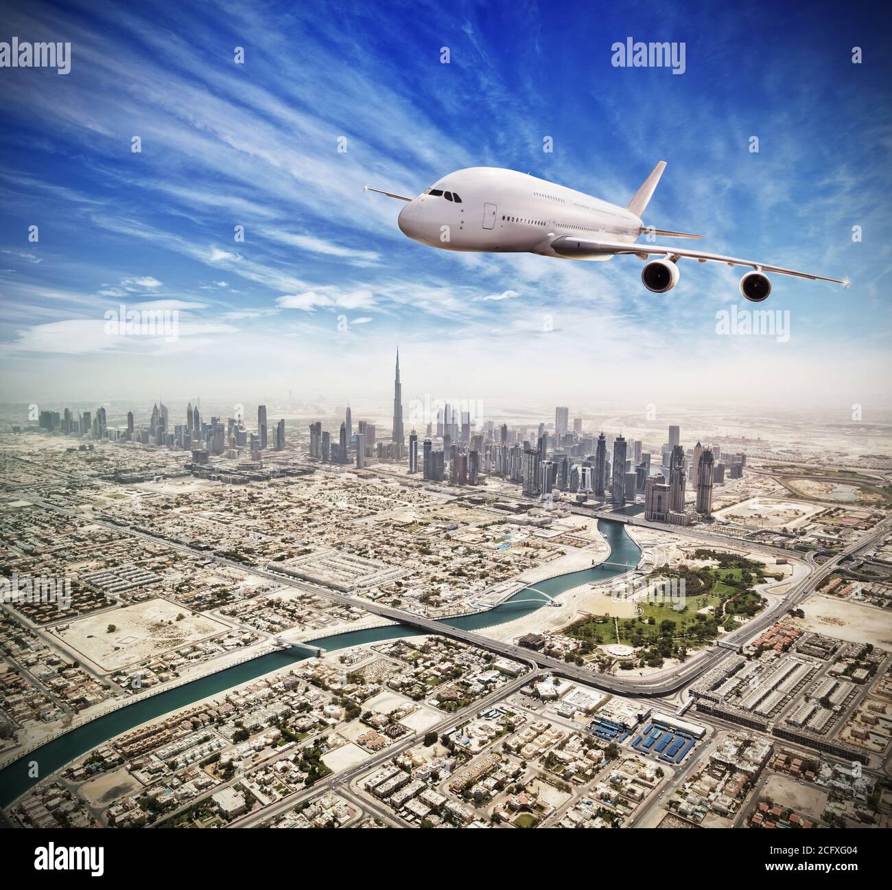 Huge commercial jetliner flying above Dubai city, UAE. Modern and ...