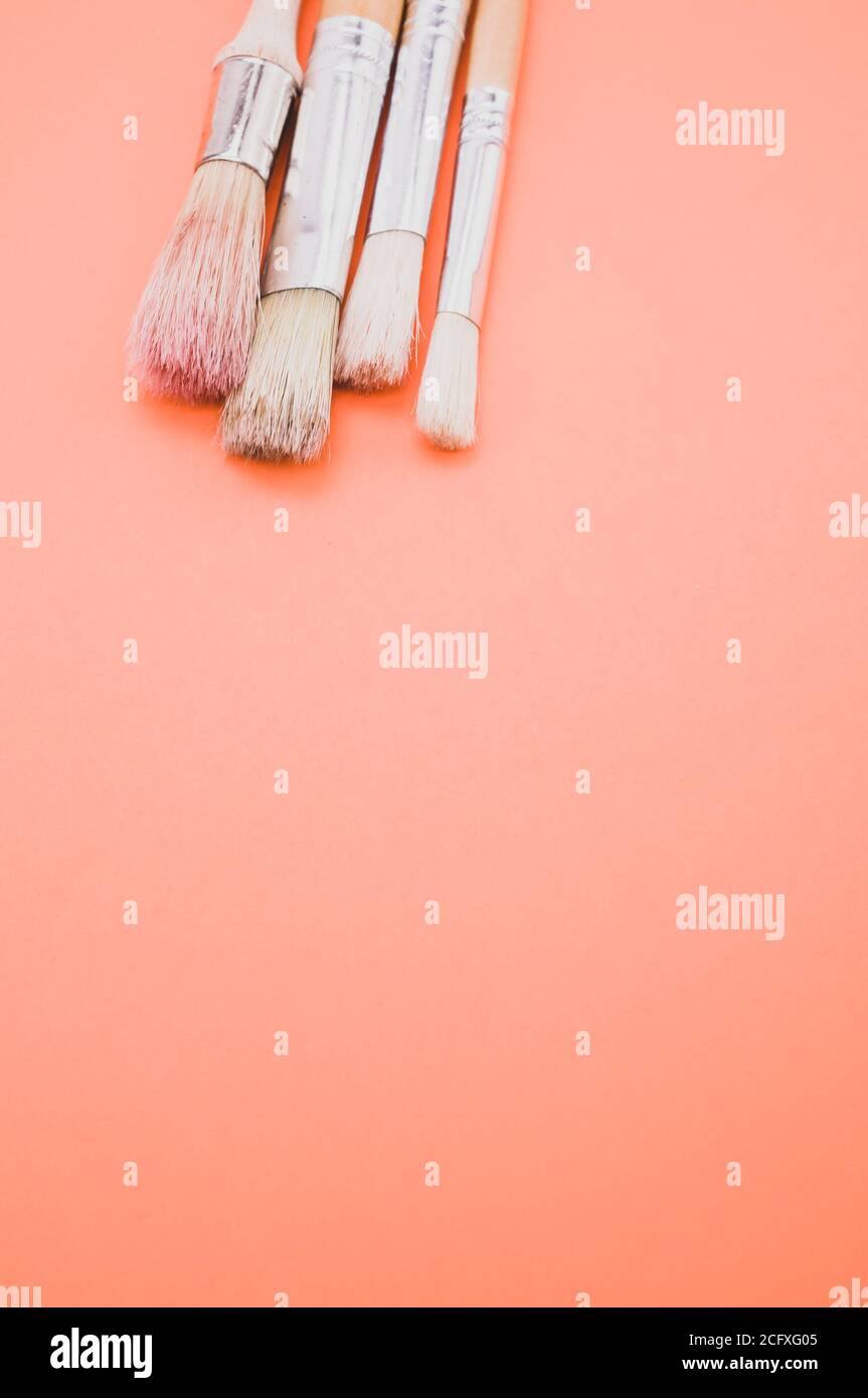 Vertical closeup focus shot of paintbrushes on an orange surface Stock ...
