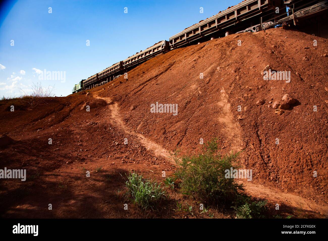 Bauxite clay open-cut mining. Cargo train with aluminium ore on loading ...