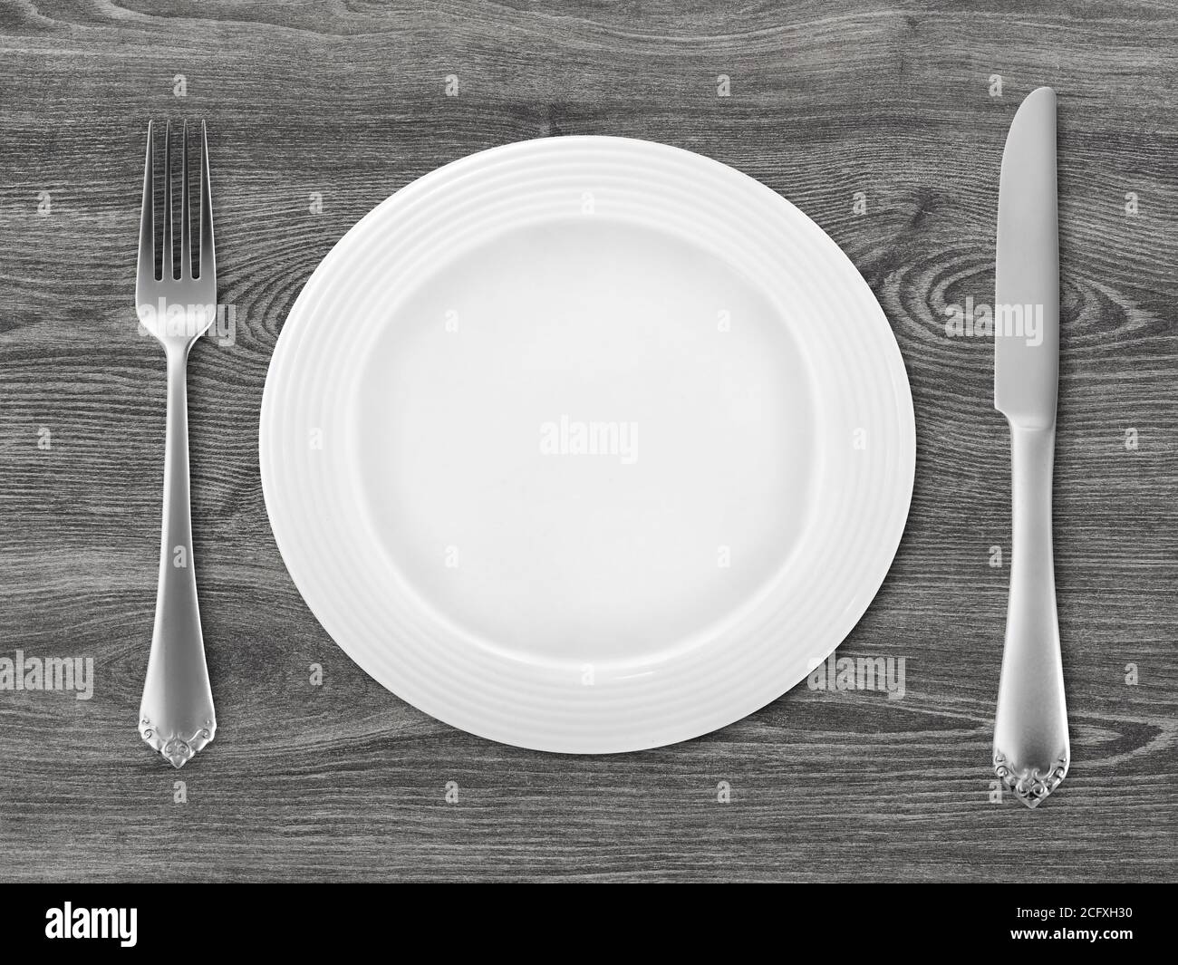 Knife, fork and plate Stock Photo - Alamy