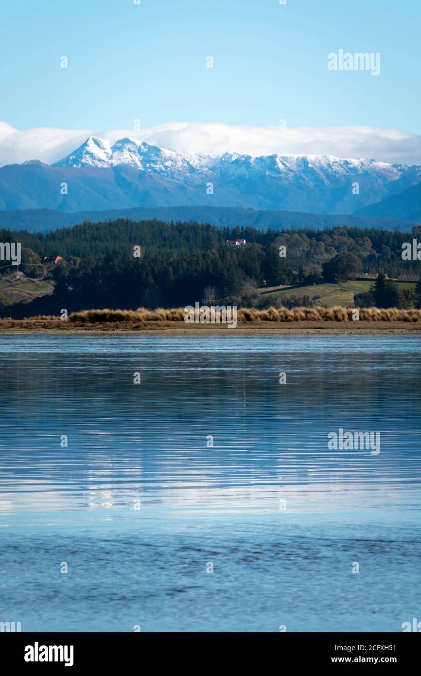 Waimea Inlet with snow capped Mount Arthur Range in distance, Mapua ...