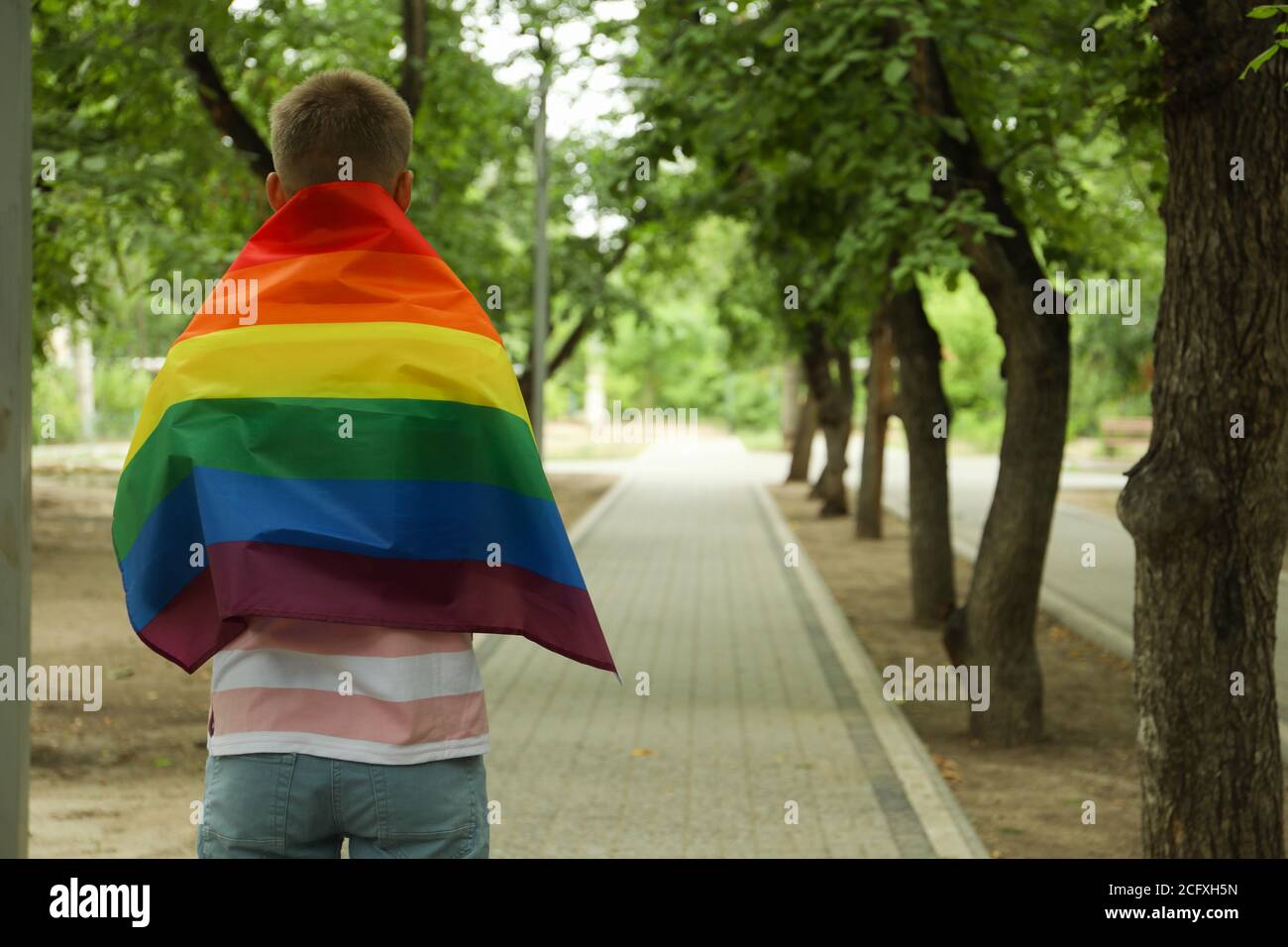 Young man with LGBT flag standing outdoor Stock Photo - Alamy