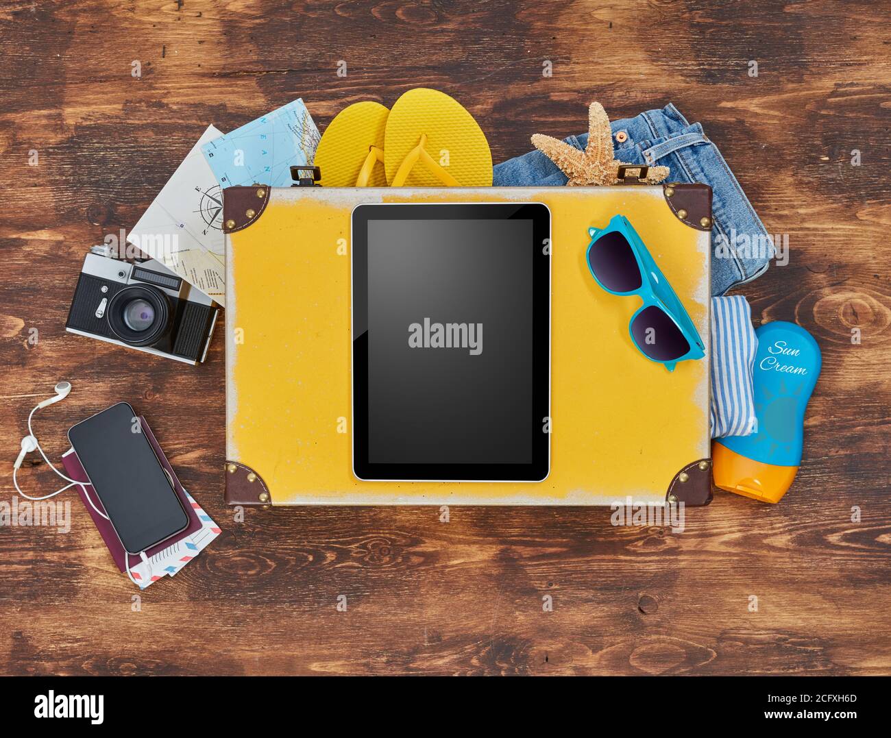 Digital tablet, suitcase, clothing and personal accessories Stock Photo ...