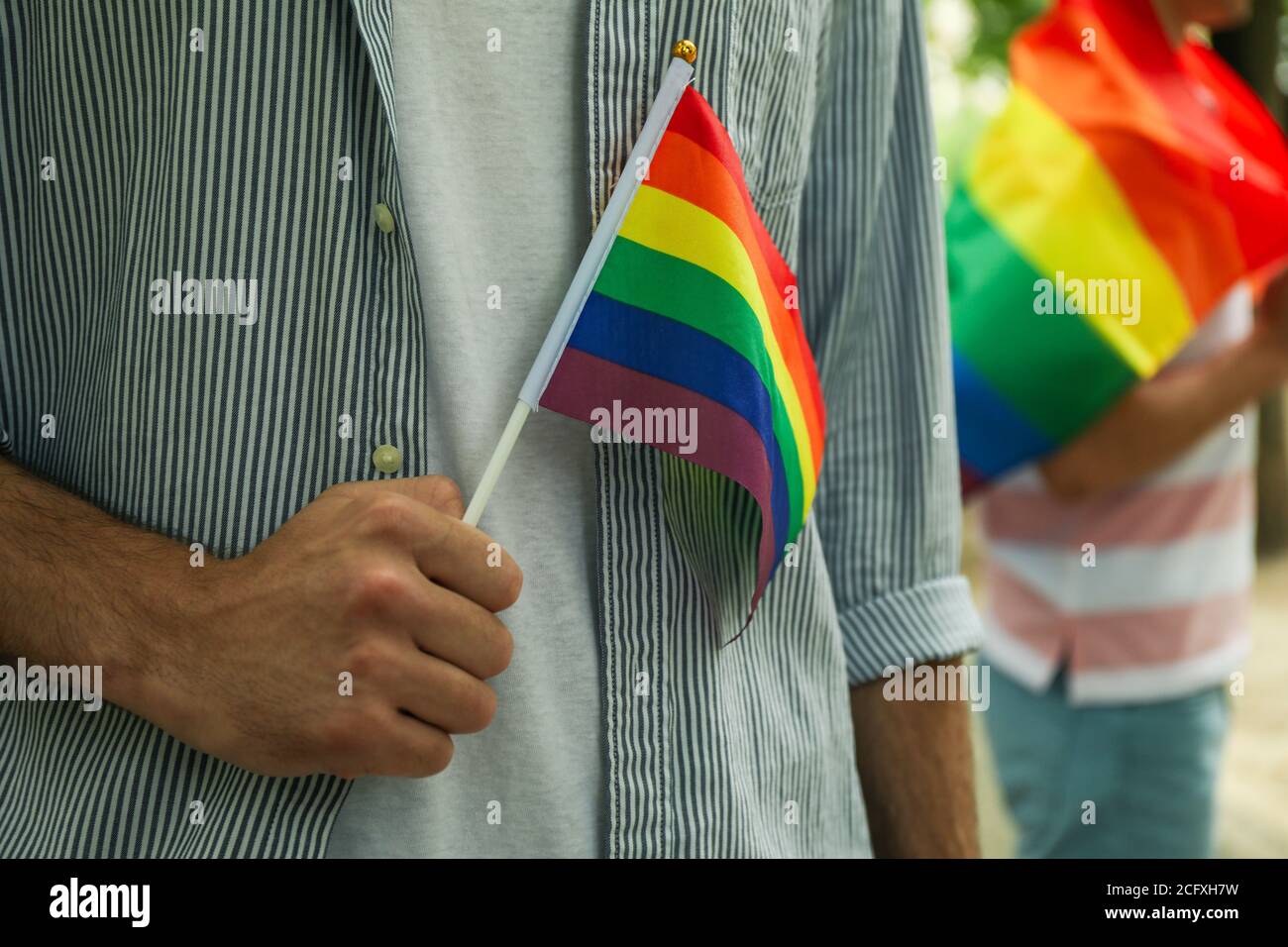 Young men with LGBT flag standing outdoor Stock Photo - Alamy