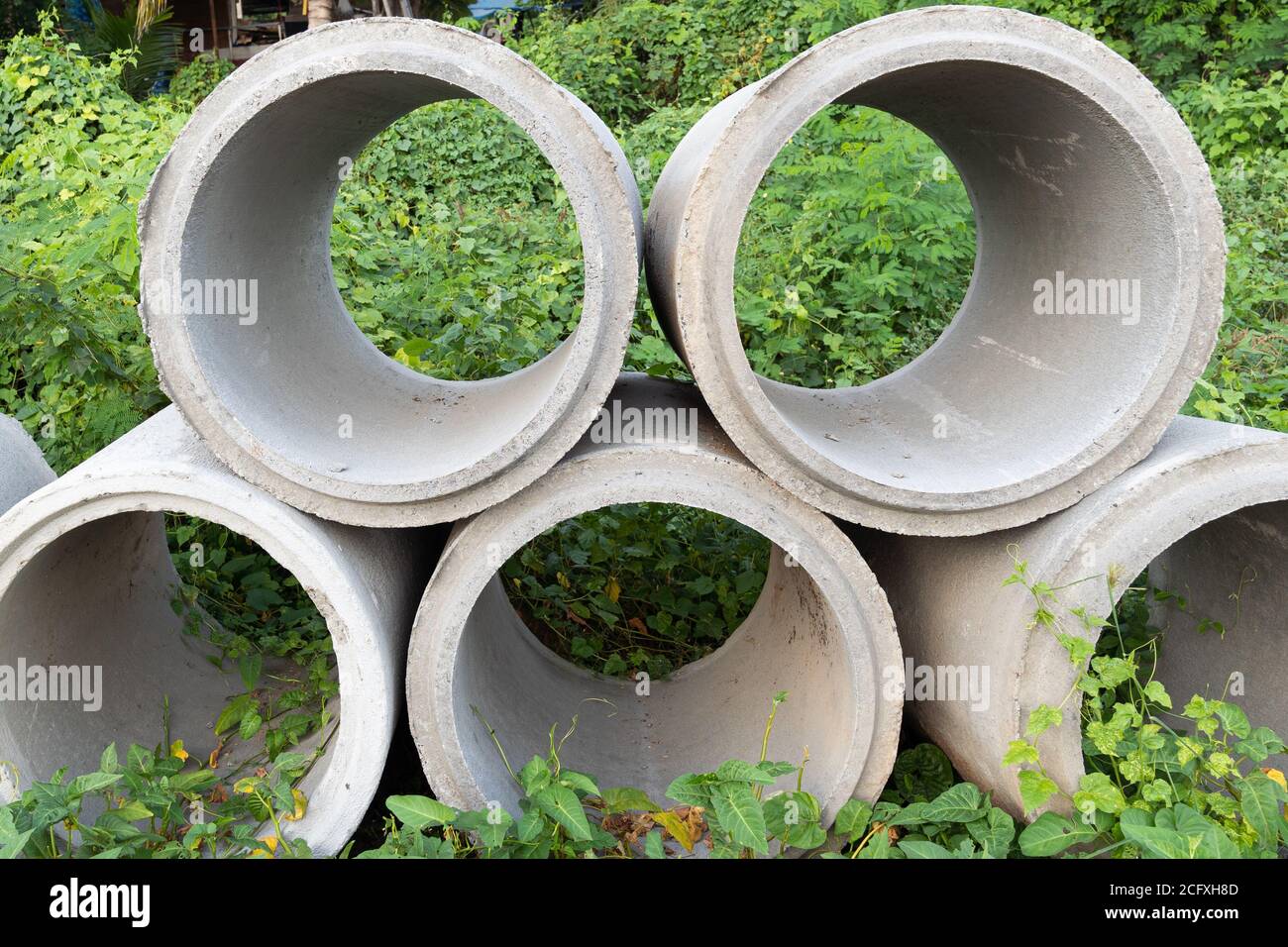 Close up. Concrete pipes used for drainage and road side in a big city ...