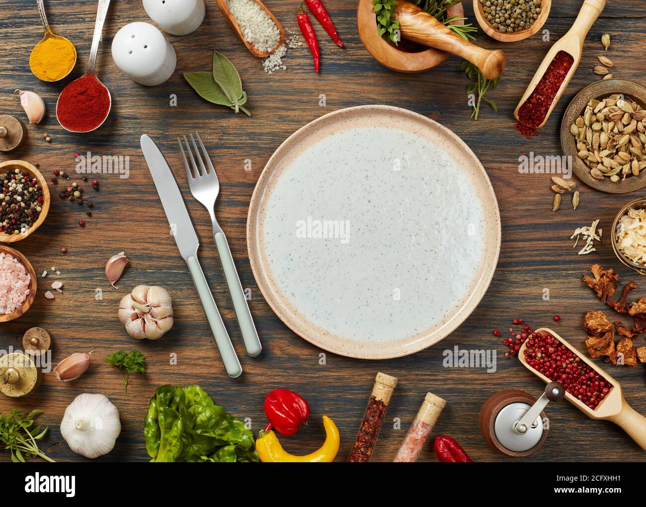 Empty plate, silverware and ingredients on wood table Stock Photo - Alamy