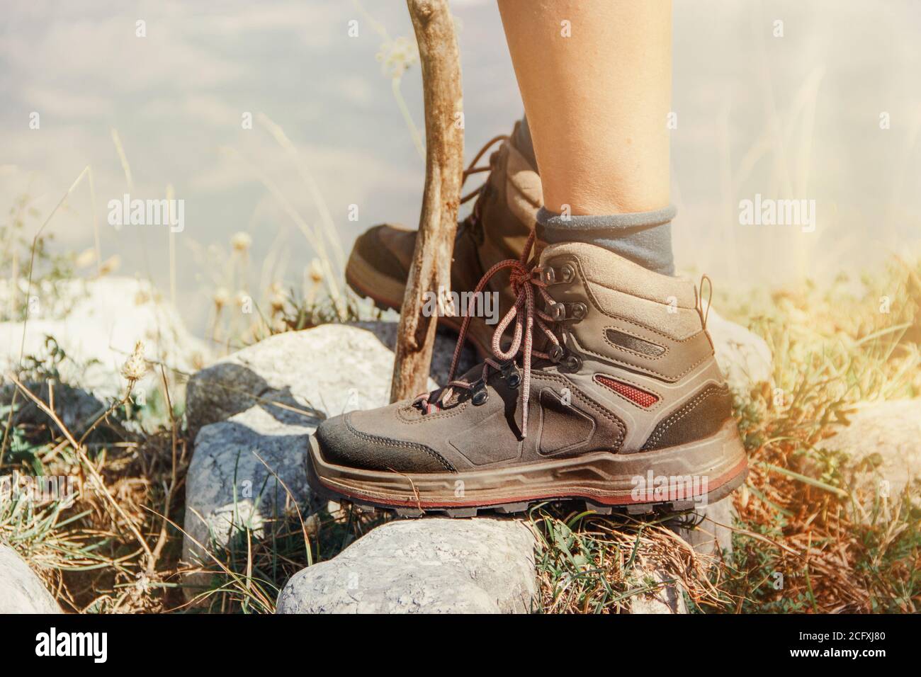 Close up of women legs wearing hiking boots stainding in mountain ...