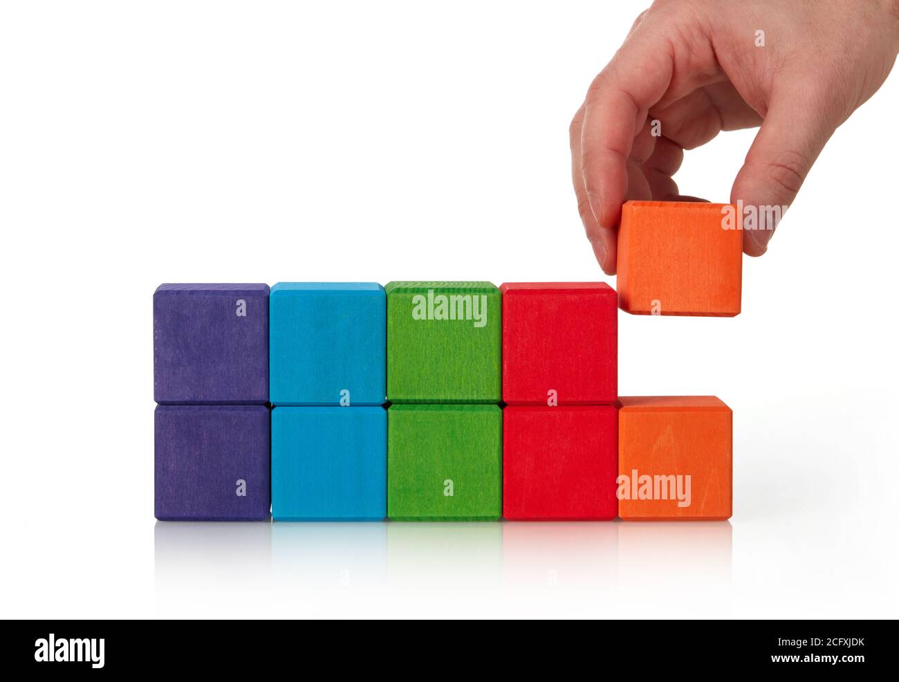 Wooden toy blocks on white background Stock Photo - Alamy