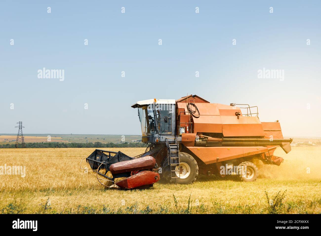 Red combine harvester in barley field. Agriculture and farming Stock ...
