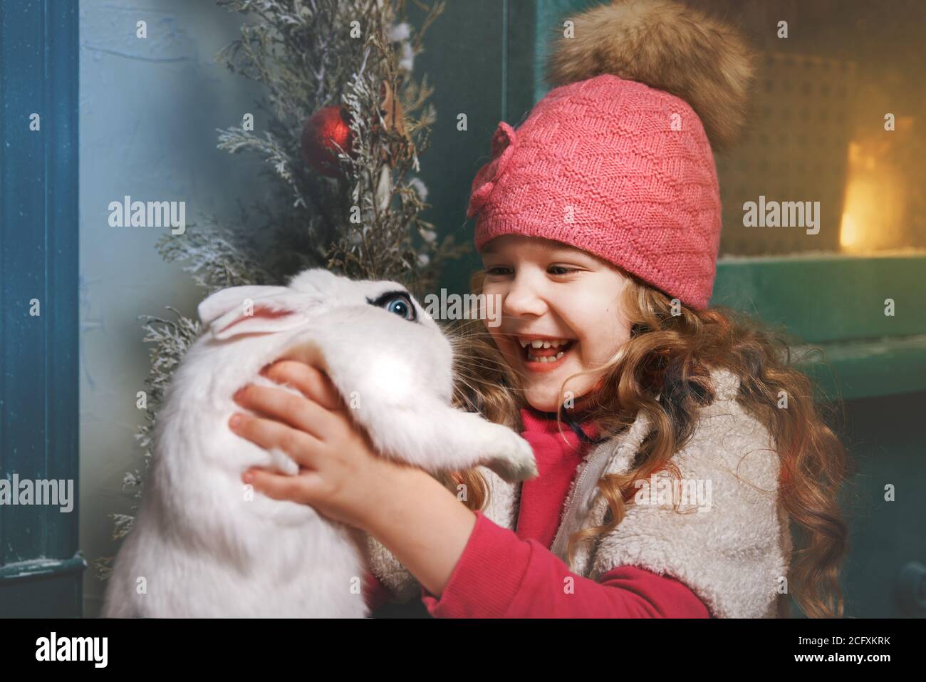 happy little girl holding a white rabbit in her arms Stock Photo - Alamy
