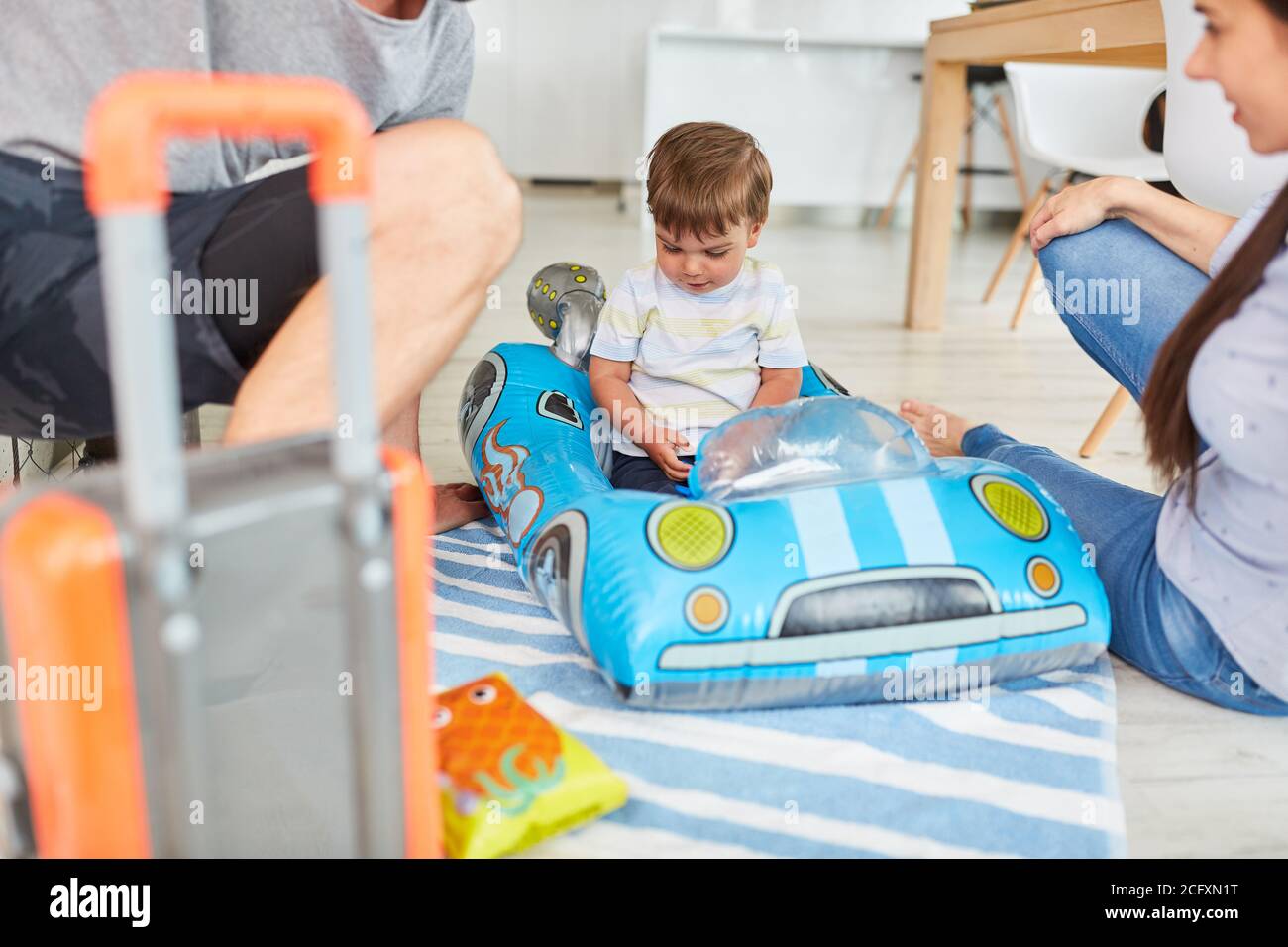 Child drives in the racing car as a children's vehicle in the living ...