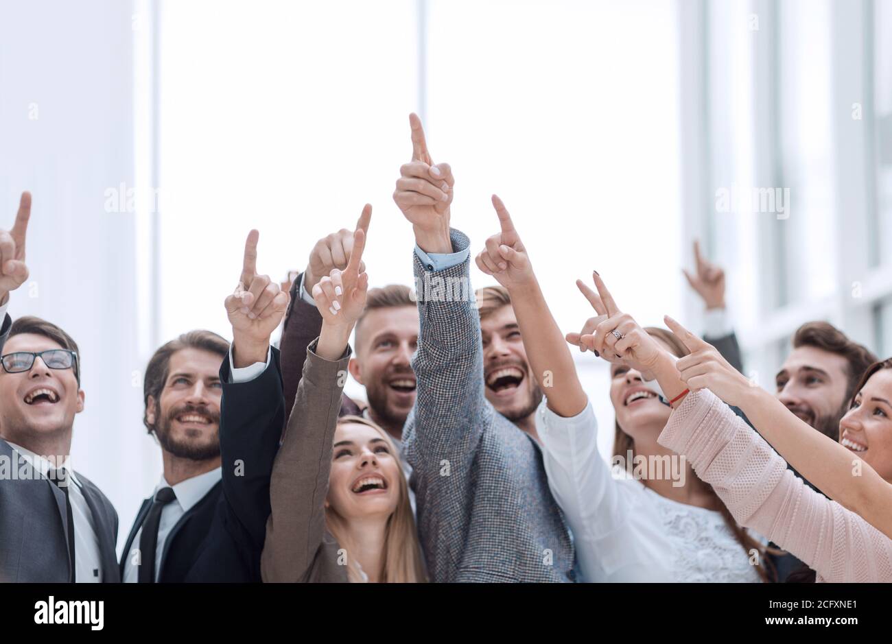 close up. group happy young people, pointing far the upward Stock Photo ...