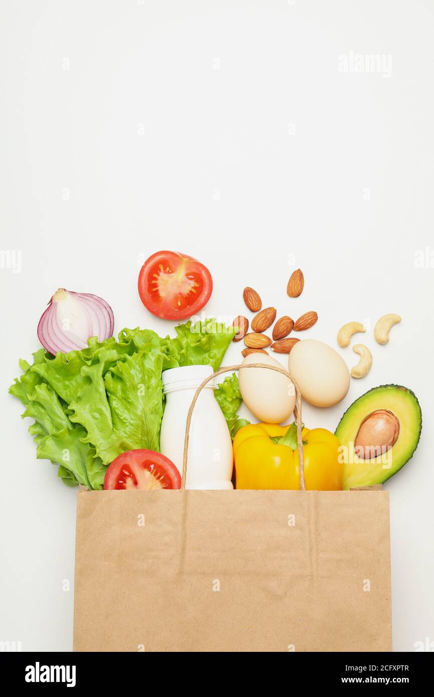 Paper bag with different food on white background Stock Photo - Alamy