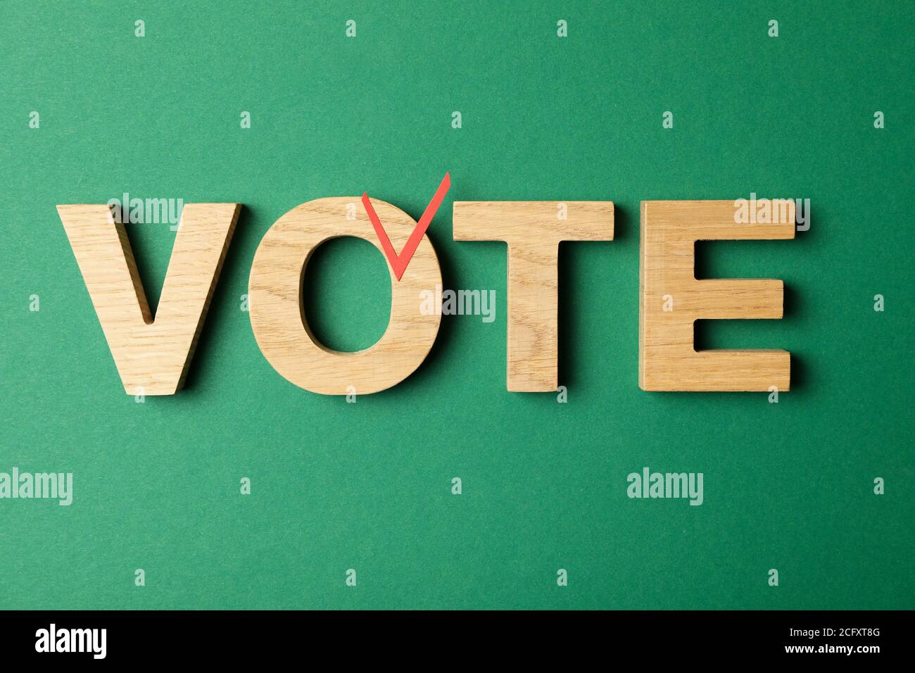 Word Vote made of wooden letters on green background Stock Photo - Alamy