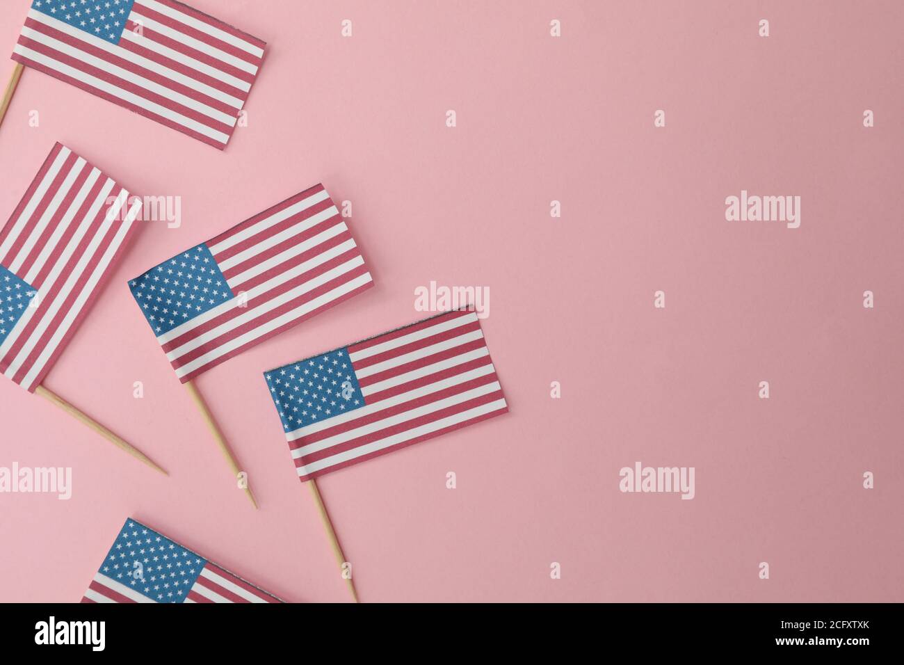 American flags on pink background, space for text Stock Photo - Alamy