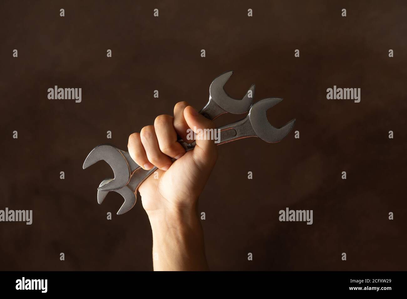 Hand with wrenches hi-res stock photography and images - Alamy