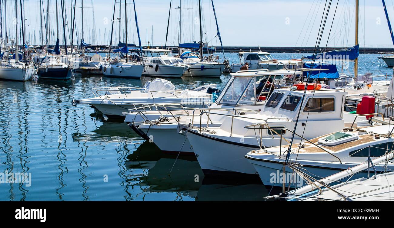 boats moored in a pier in a row mediterranean sea dock Stock Photo - Alamy