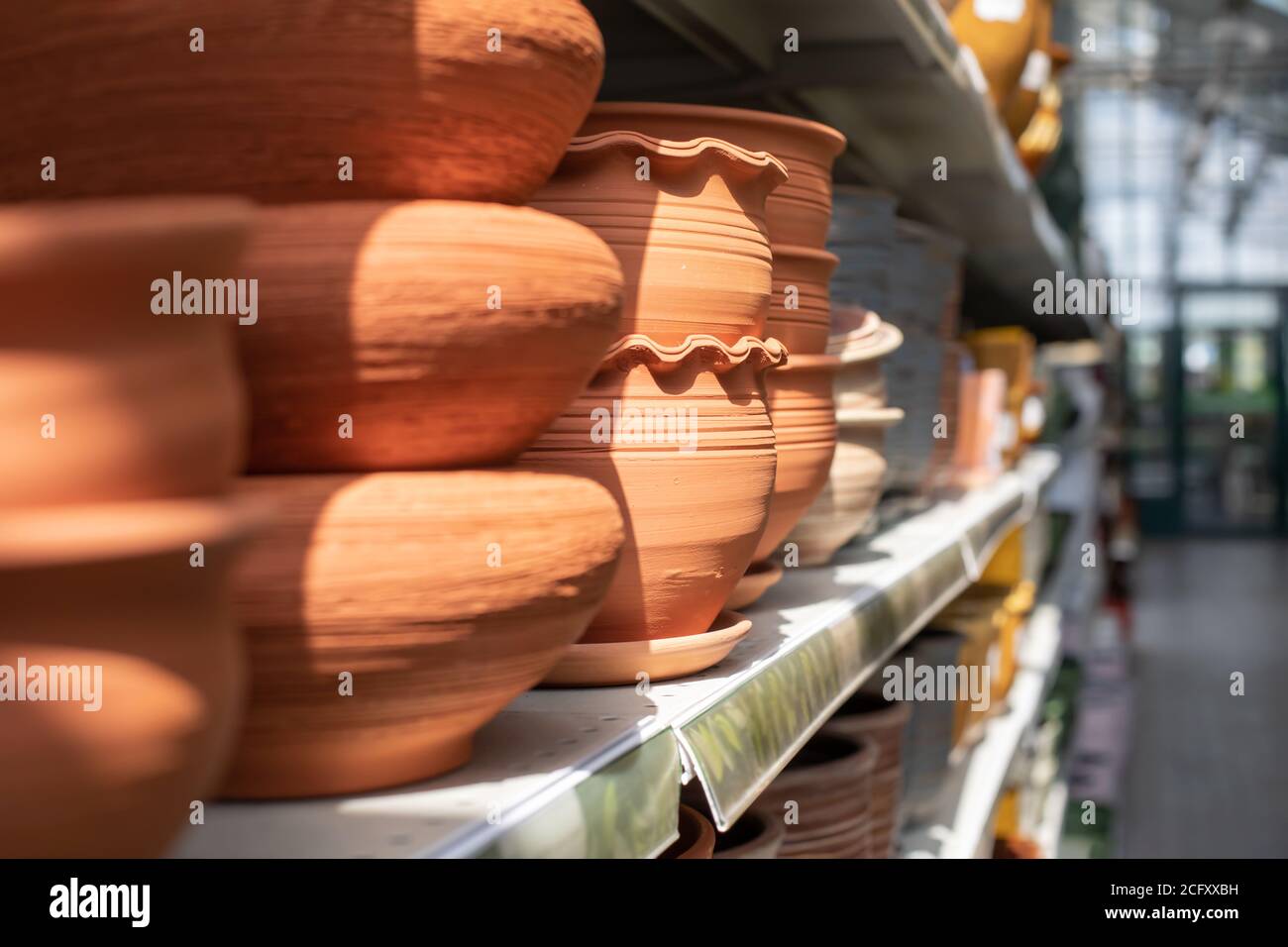 Clay flower pots on a store shelf. Defocus background perspective ...