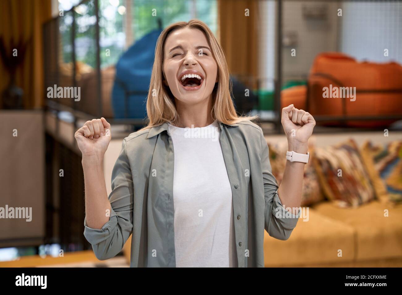 Good news at work, portrait of a young excited caucasian woman ...