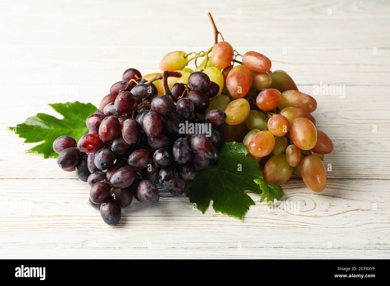 Fresh ripe grape on white wooden background Stock Photo - Alamy