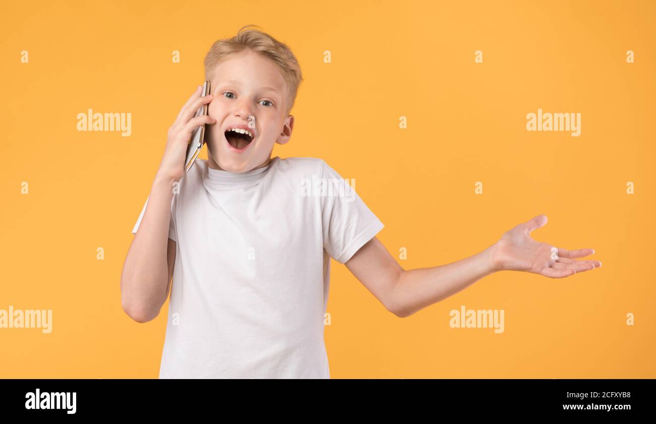 Excited boy talking on the phone and gesturing Stock Photo - Alamy