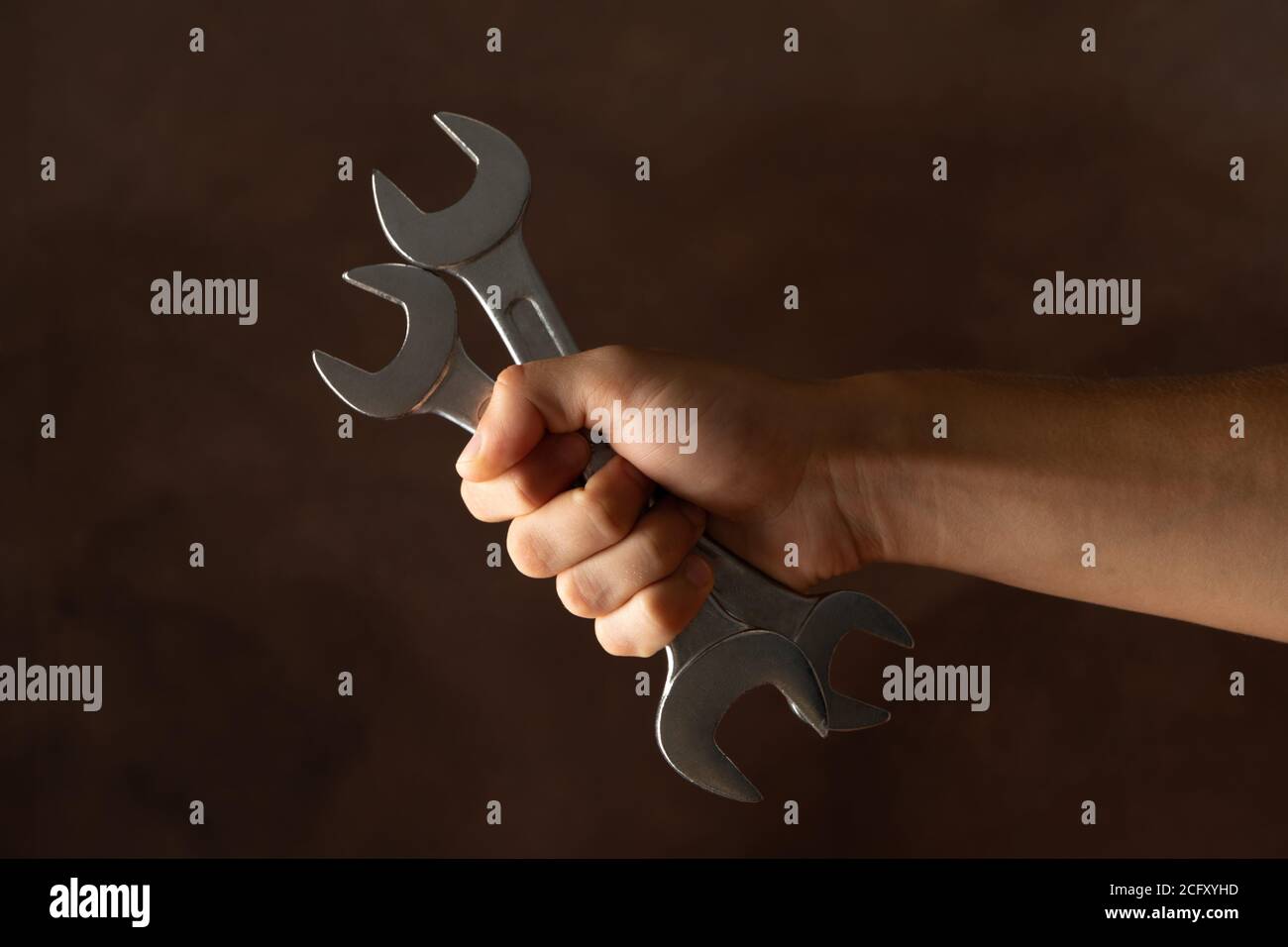 Hand with wrenches hi-res stock photography and images - Alamy