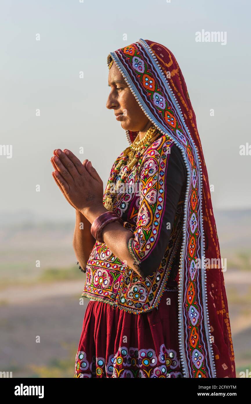 Ahir woman in traditional colorful clothes meditating at sunset hi-res ...