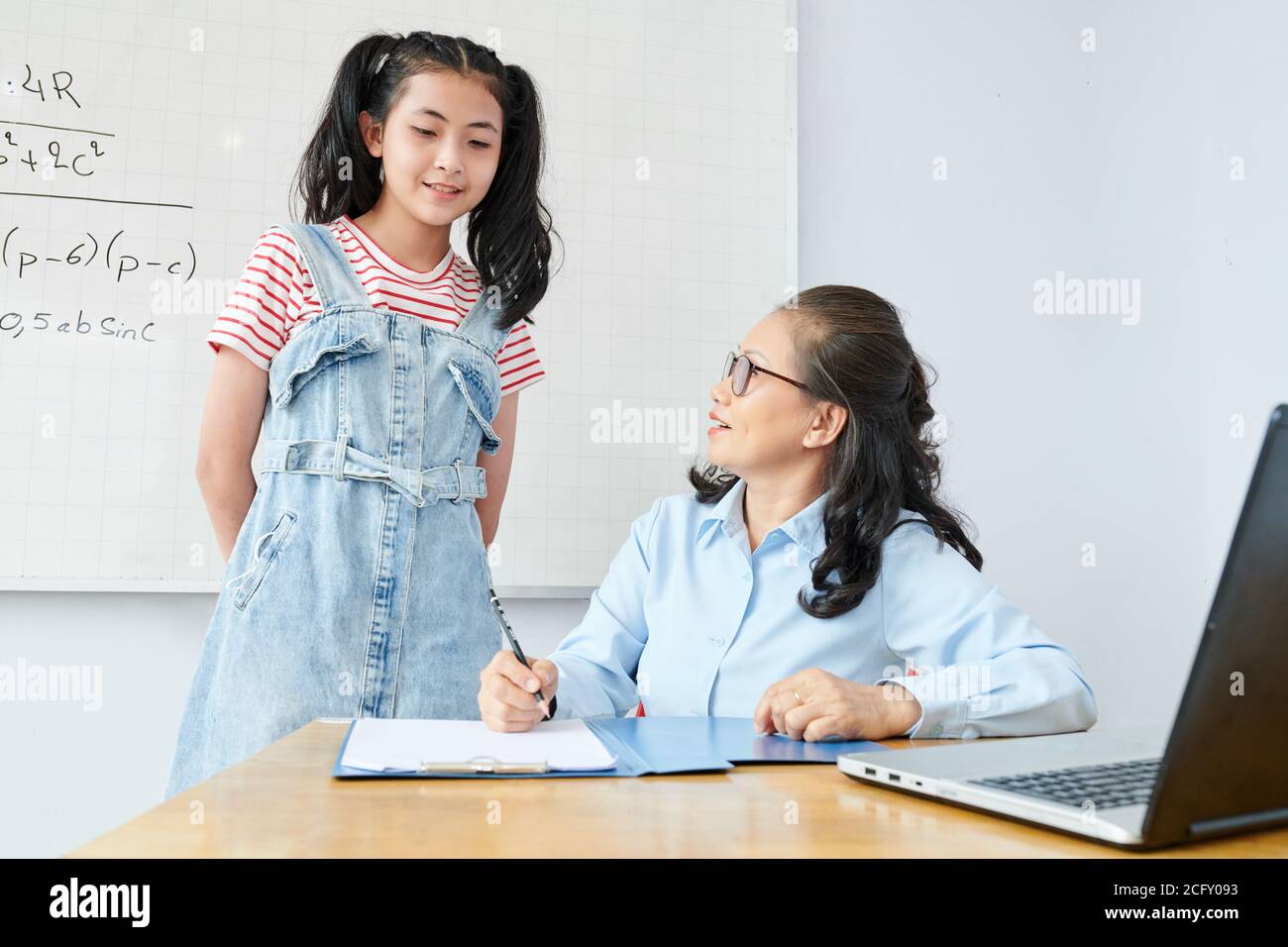 Teacher checking math test Stock Photo - Alamy