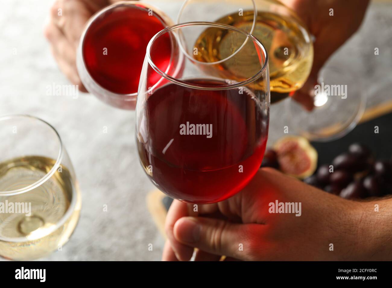 Three men cheer with wine glasses, close up Stock Photo - Alamy