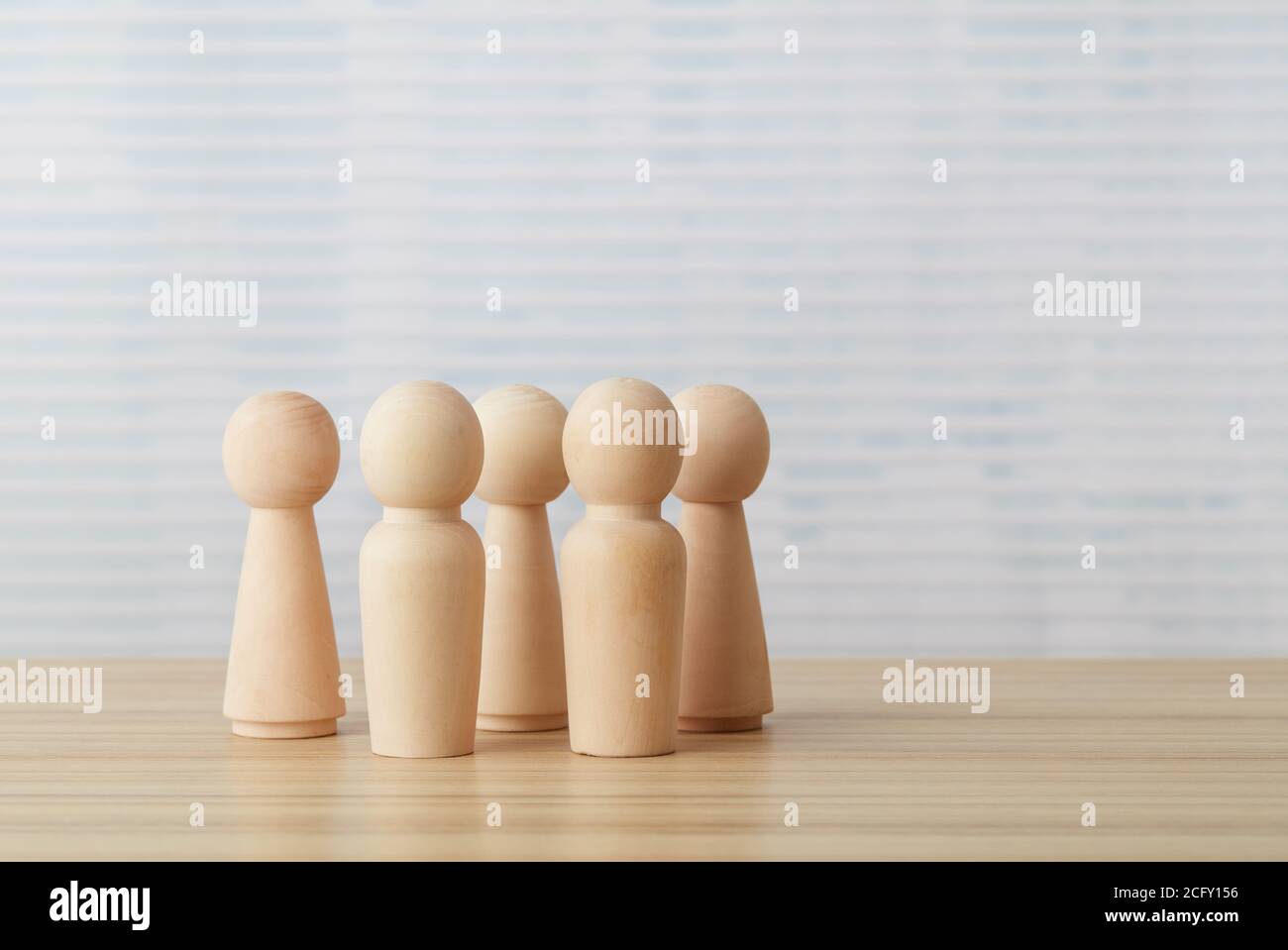 Wooden people figures on desk table Stock Photo - Alamy