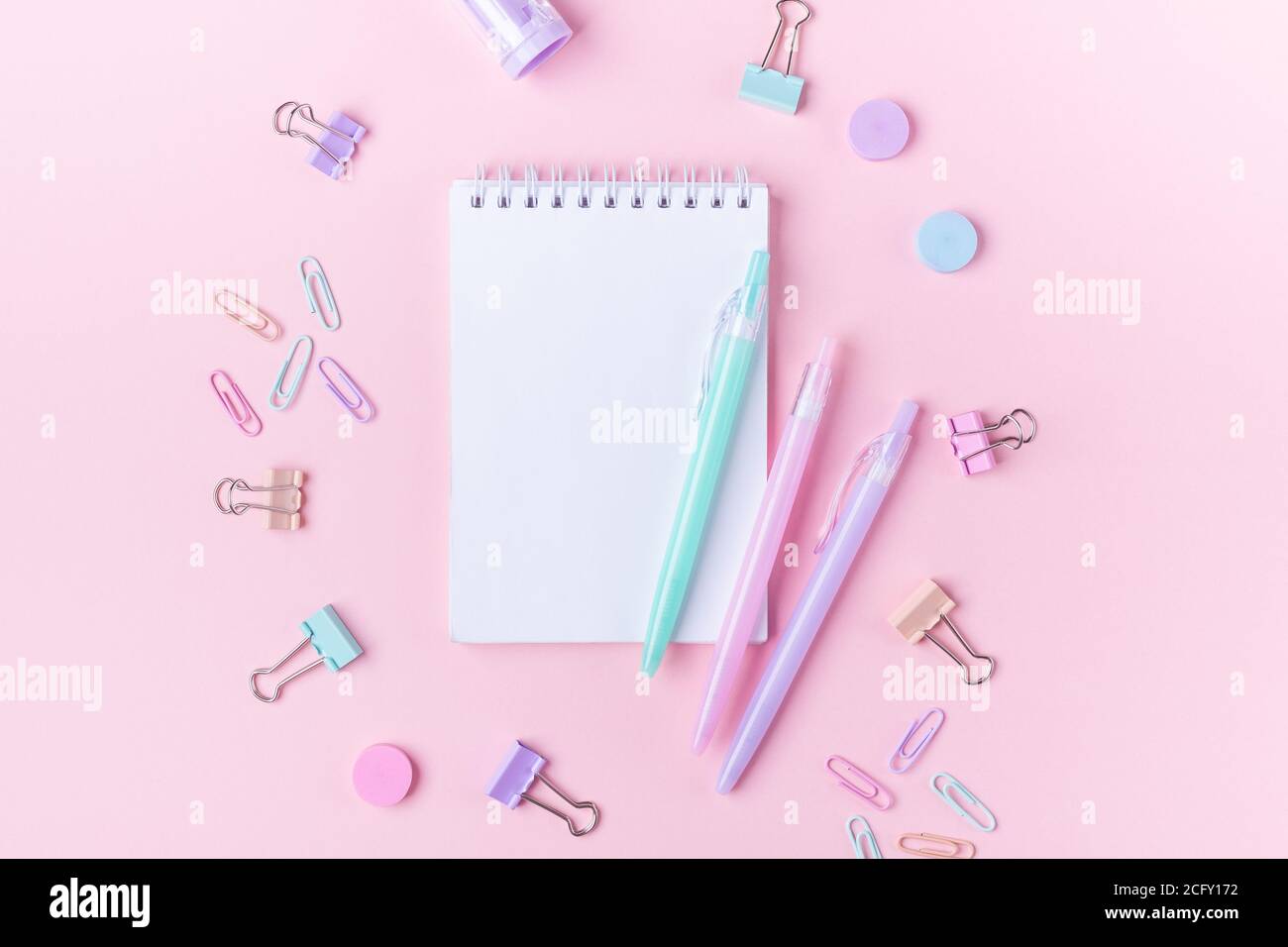 School background with notebooks and pastel colorful study accessories ...