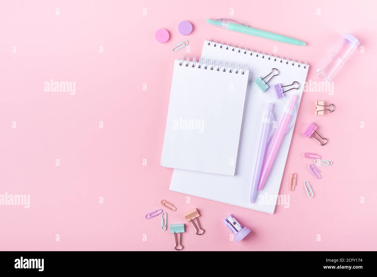 School background with notebooks and pastel colorful study accessories ...