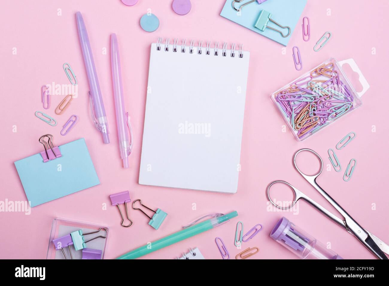 School background with notebooks and pastel colorful study accessories ...