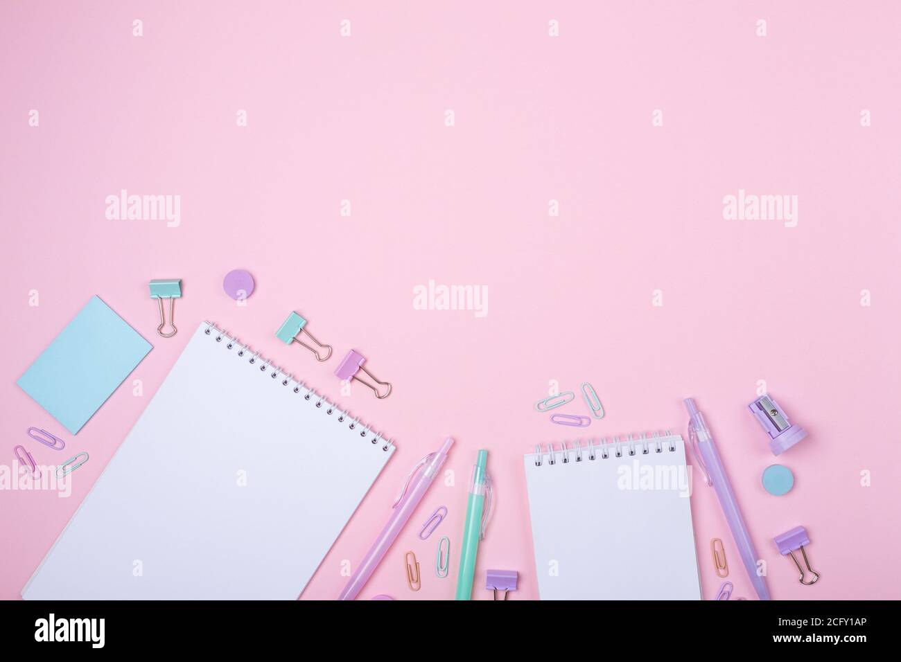 School background with notebooks and pastel colorful study accessories ...