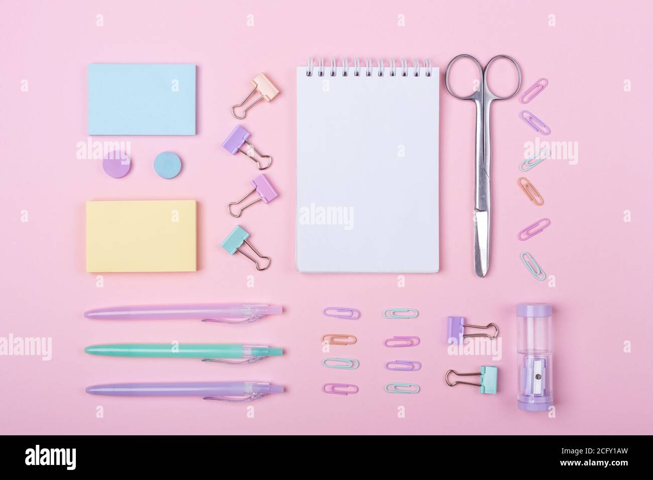 School background with notebooks and pastel colorful study accessories ...