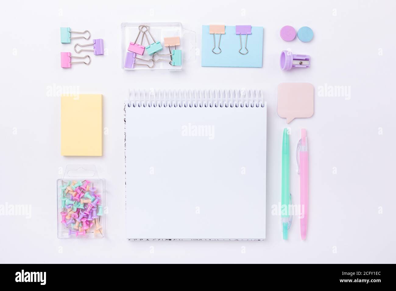 School background with notebook and pastel colorful study accessories ...