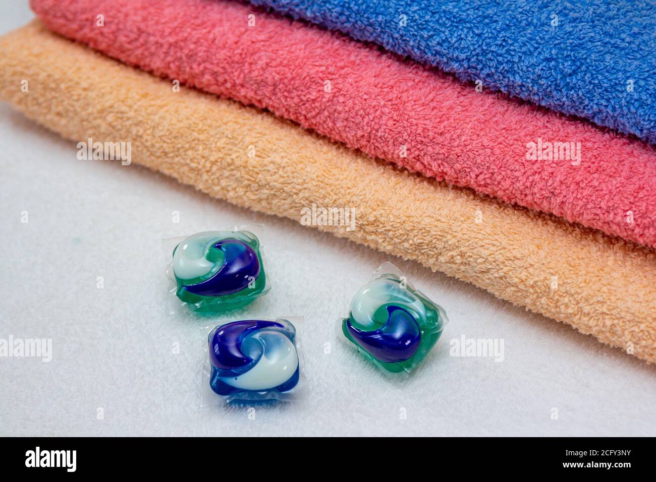 Laundry detergent pods for washing machine and colorful bath towels ...