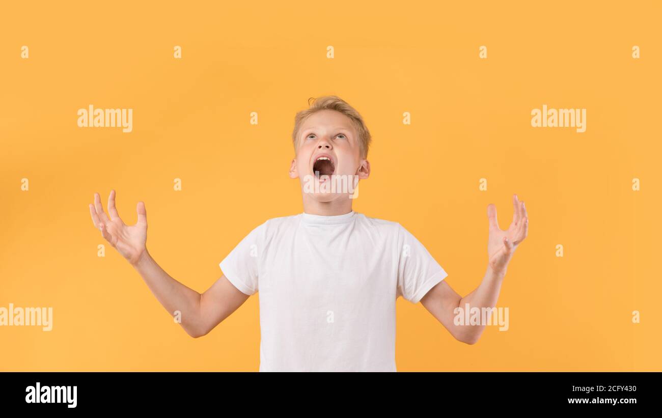 Emotional boy screaming, looking up and gesturing Stock Photo - Alamy