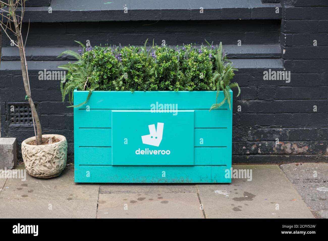 Deliveroo sign painted on plant pot planter in the Custard Factory in ...